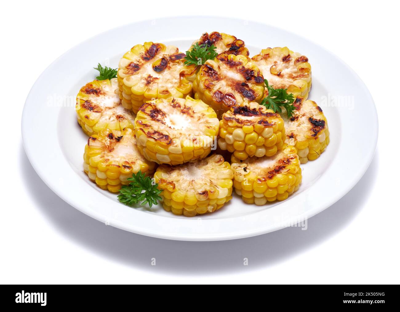 Grilled Slices of corn cobs with stripes from a grill in ceramic plate ...