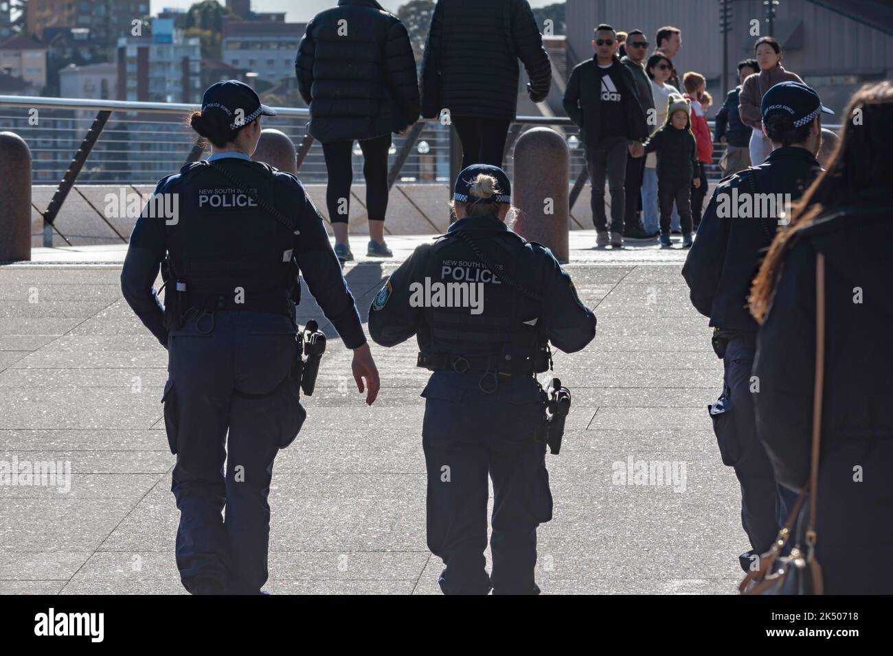 Three New South Wales Police officers on morning foot patrol, carrying ...