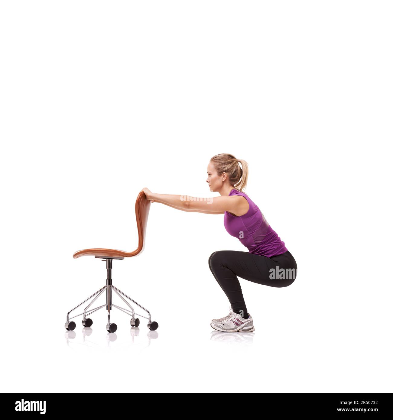 Keeping her legs lean. A beautiful young woman wearing gym clothes and ...