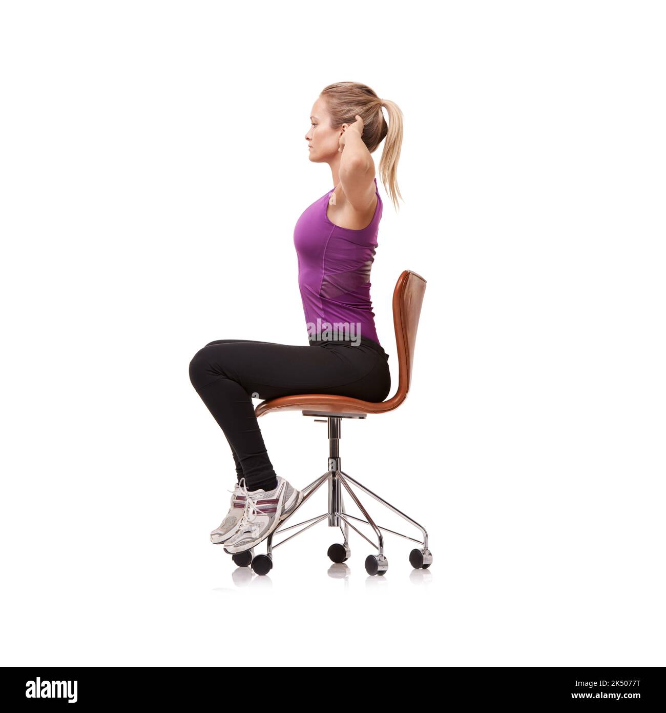 Perfect for your posture. a sporty woman doing stretches on a chair ...