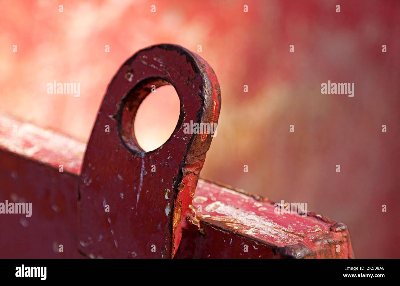 a loop of red colored metal with a blurred background Stock Photo - Alamy