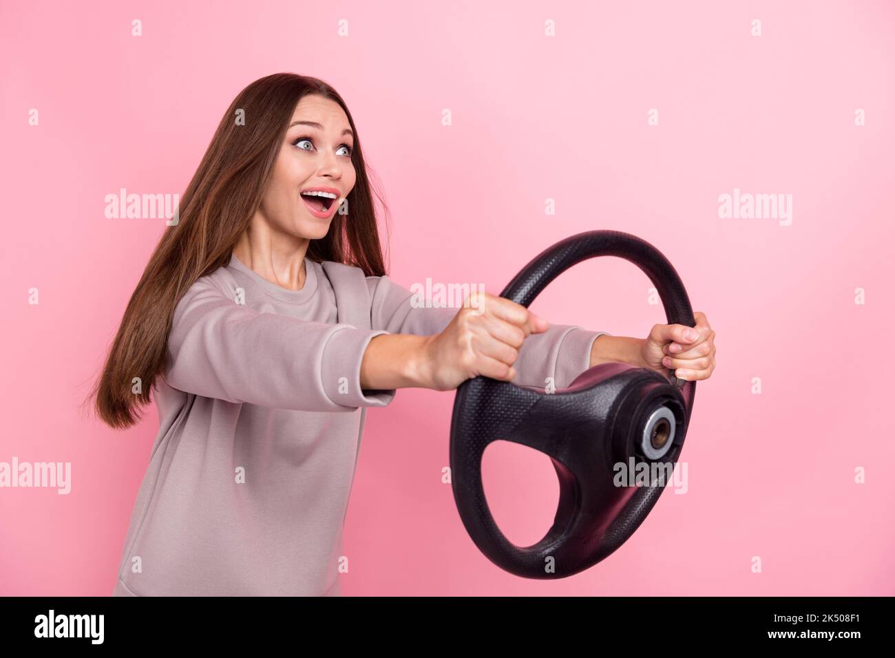 Profile portrait of astonished positive person arms hold wheel look ...
