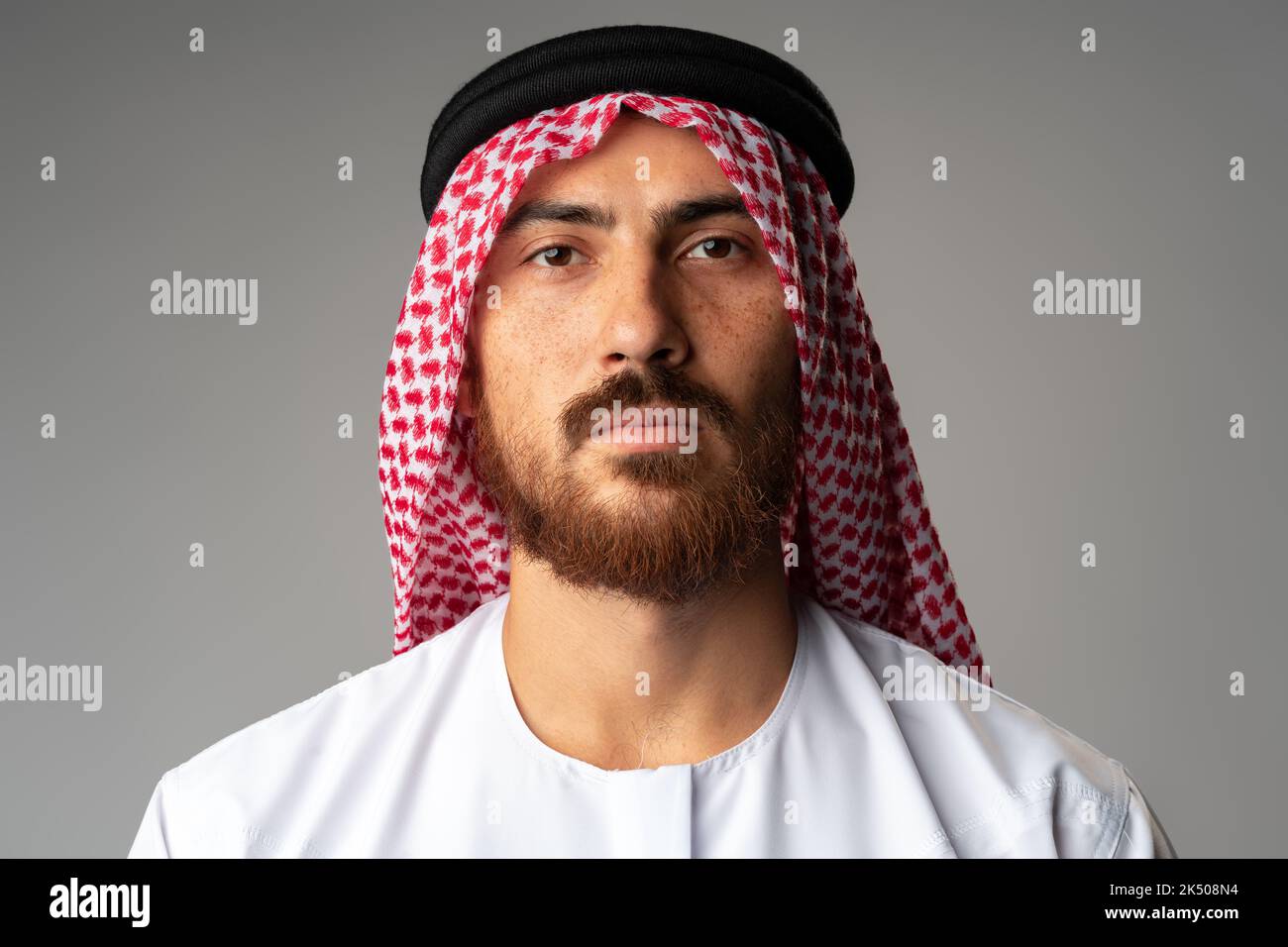 Portrait of young Arab man on gray background in studio Stock Photo - Alamy