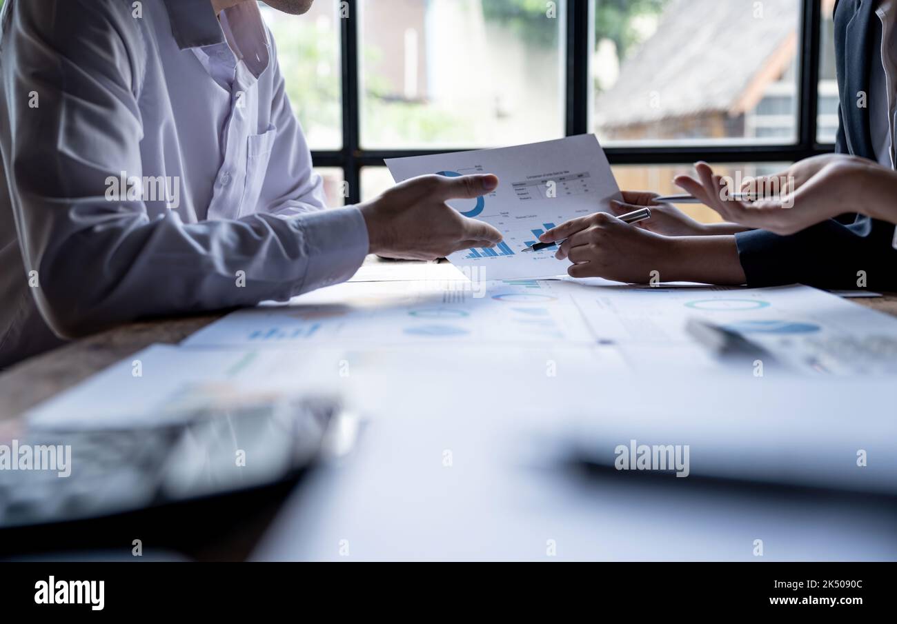 Business People Meeting using laptop computer, calculator stock market ...