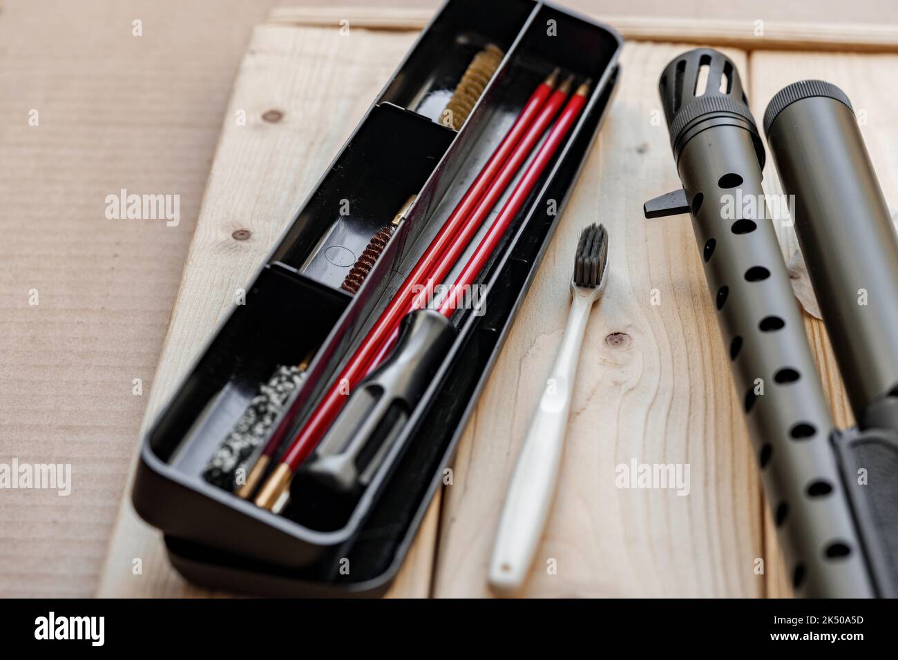 Disassembled rifle with cleaning tools on table of weapons workshop ...