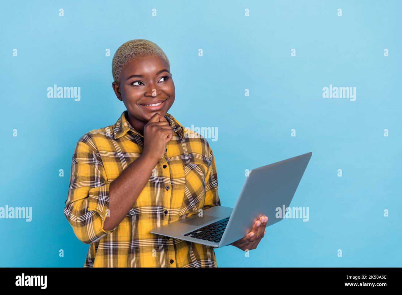 Photo of sweet dreamy woman dressed plaid shirt working modern device ...