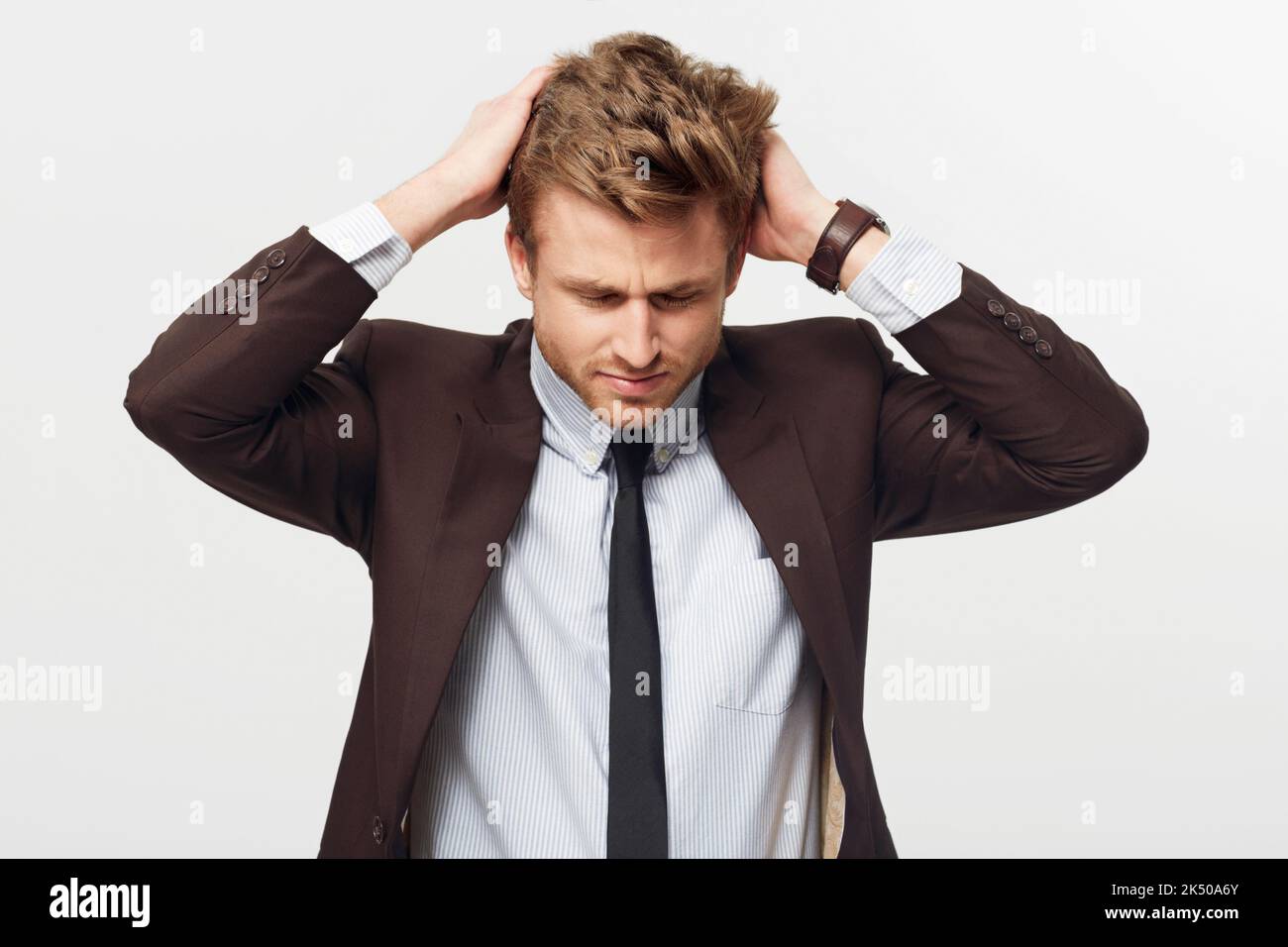 Breaking from the stress...Studio shot of a well-dressed young man ...
