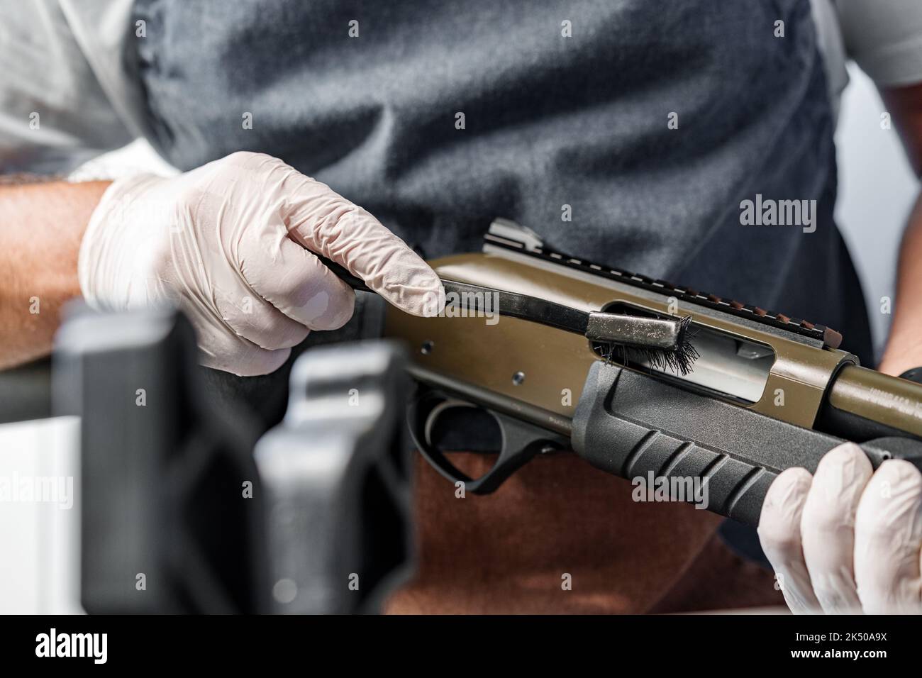 The gunsmith maintaining his rifle in a workshop Stock Photo - Alamy
