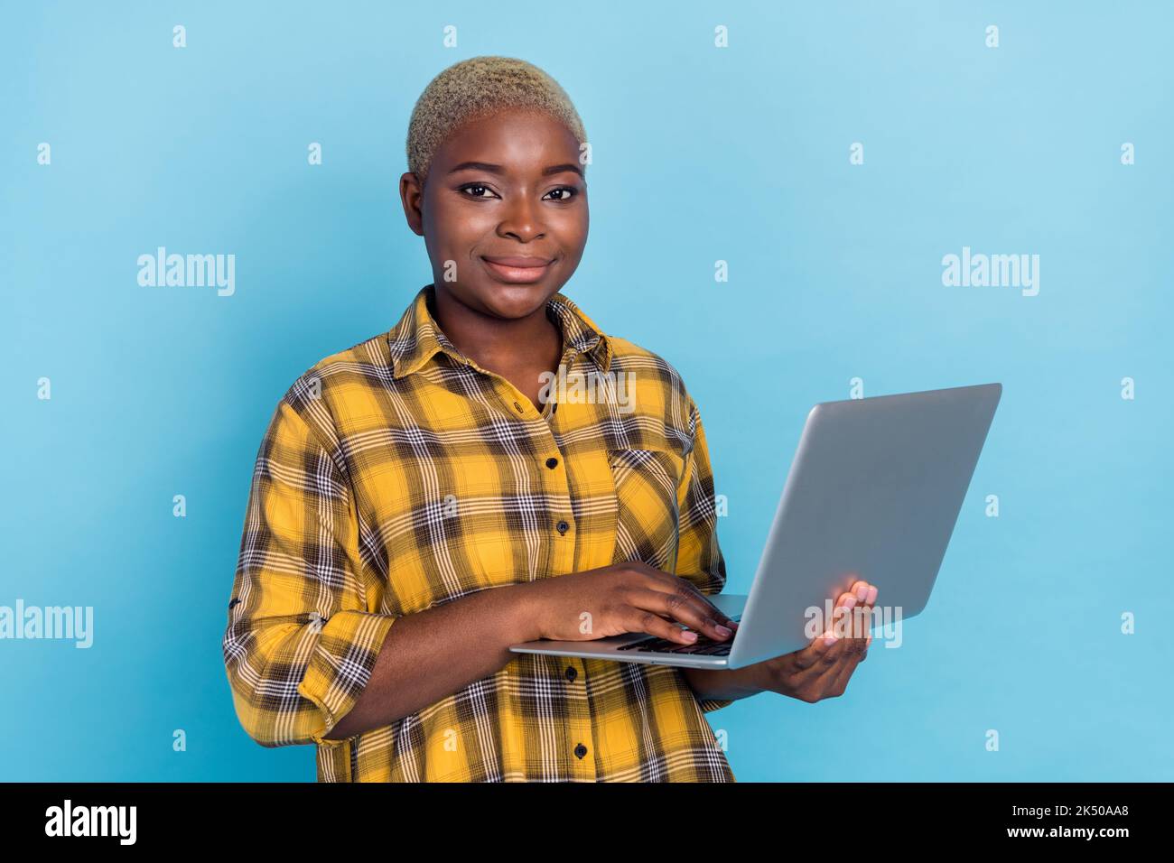 Photo of pretty sweet woman dressed plaid shirt smiling typing modern ...