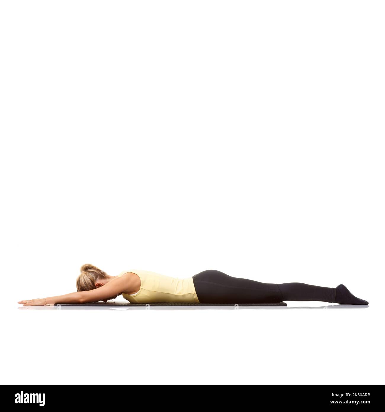 Stretching out every part of her body. A fit young woman lying on her ...