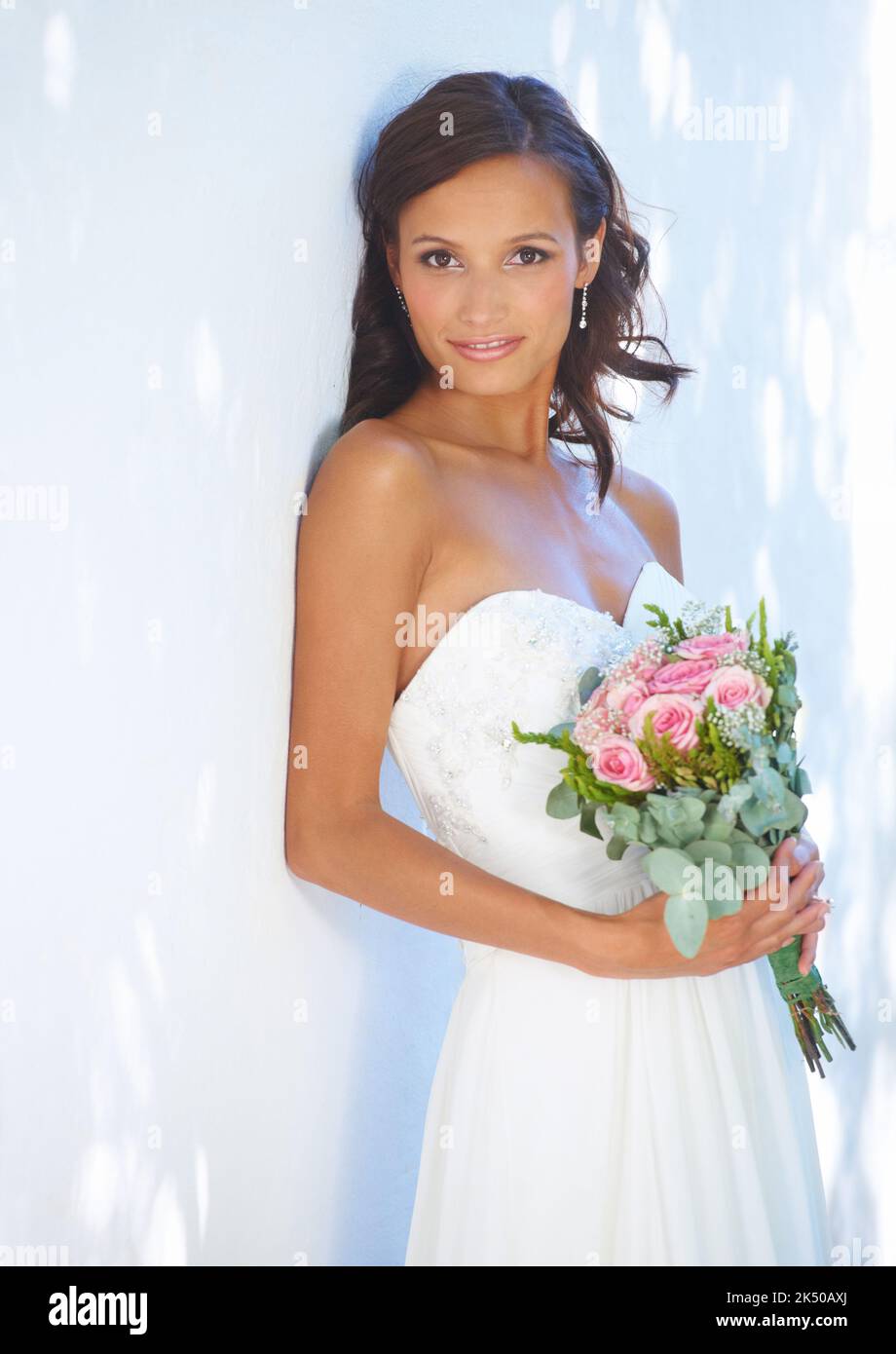 Picture perfect bride. A gorgeous bride standing outside with her ...