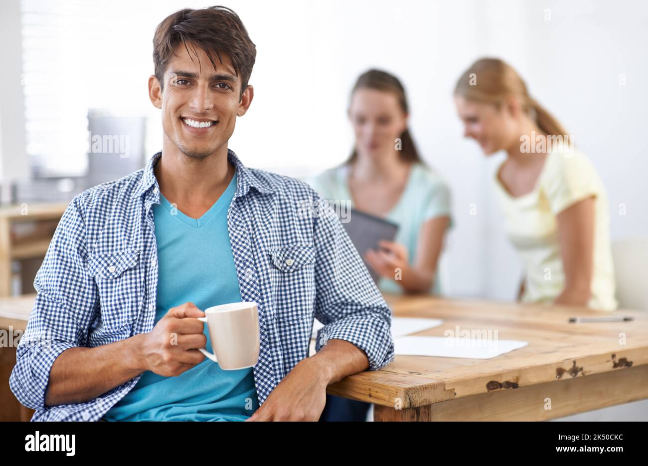 Hard work pays off. Portrait of a smiling young designer with his ...