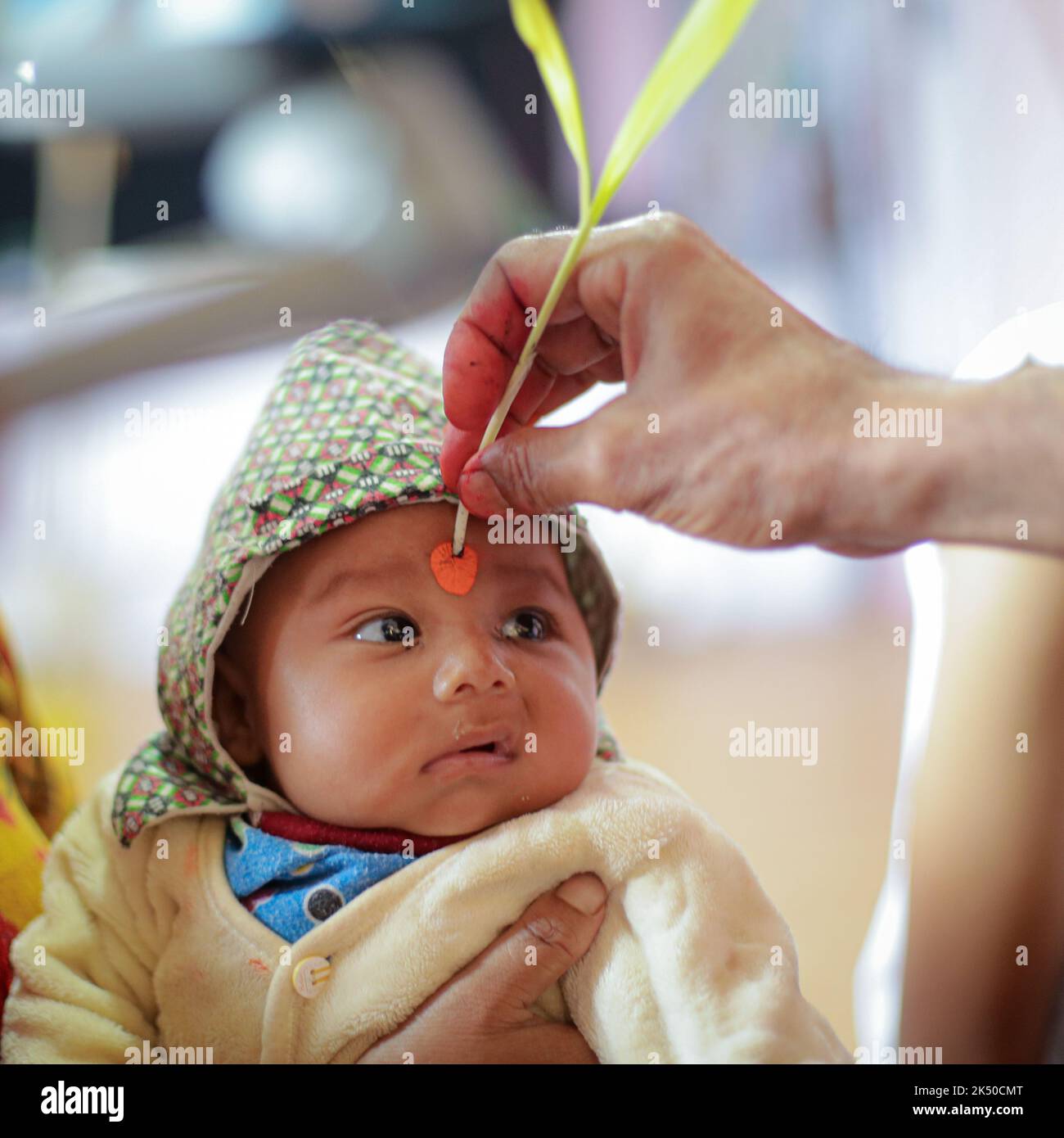 Nepal. 5th Oct, 2022. A small child receives tika and blessings from ...