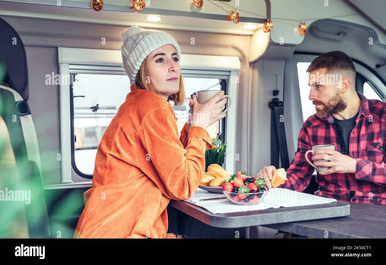 Woman having breakfast in a camper van with a friend Stock Photo - Alamy