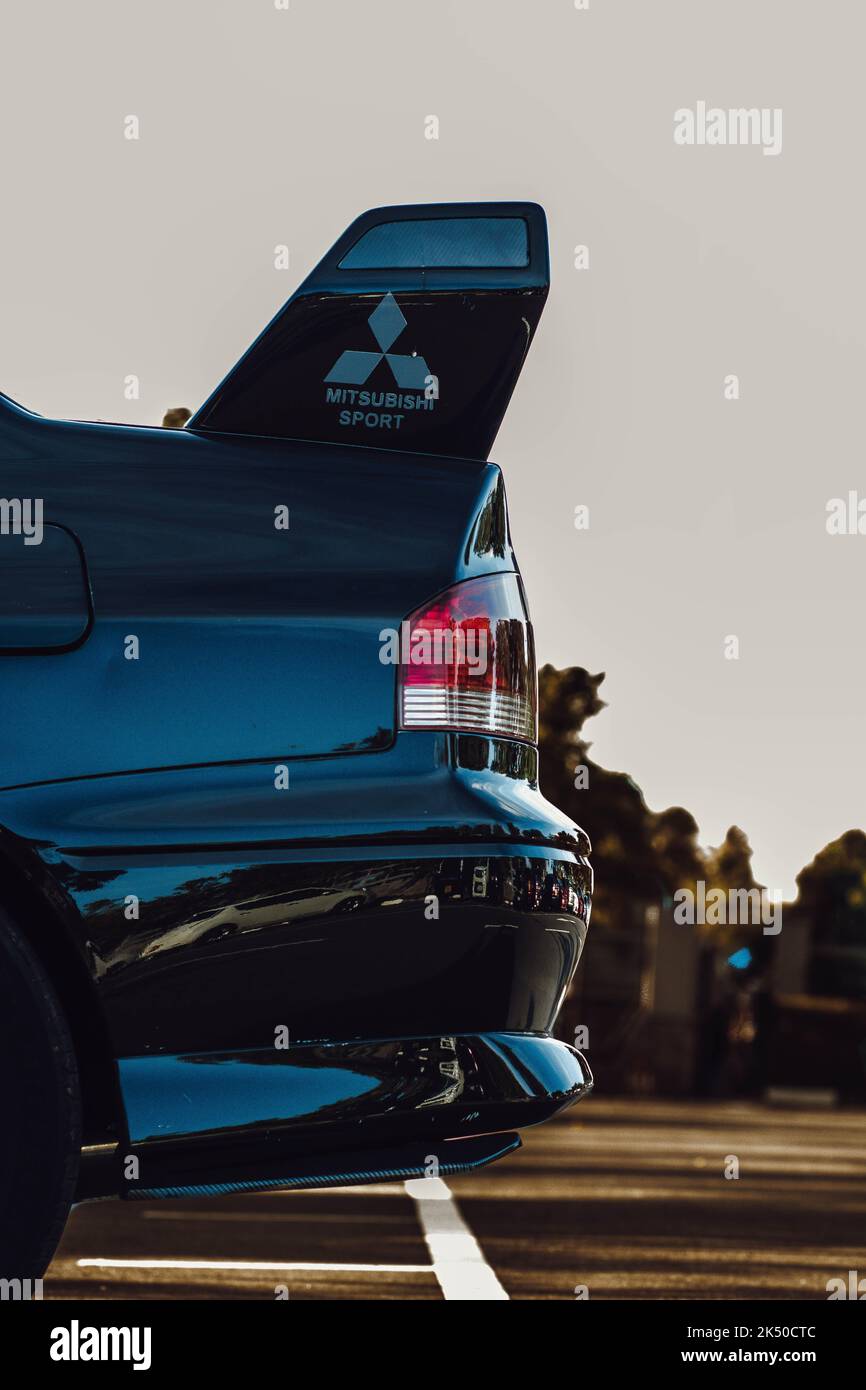 A vertical closeup of Blue Mitsubishi Evo VII logo detail Stock Photo ...