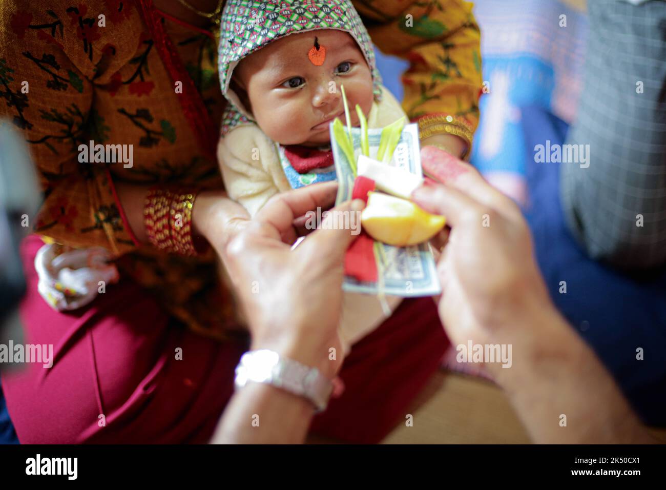 Nepal. 5th Oct, 2022. A small child receives tika and blessings from ...