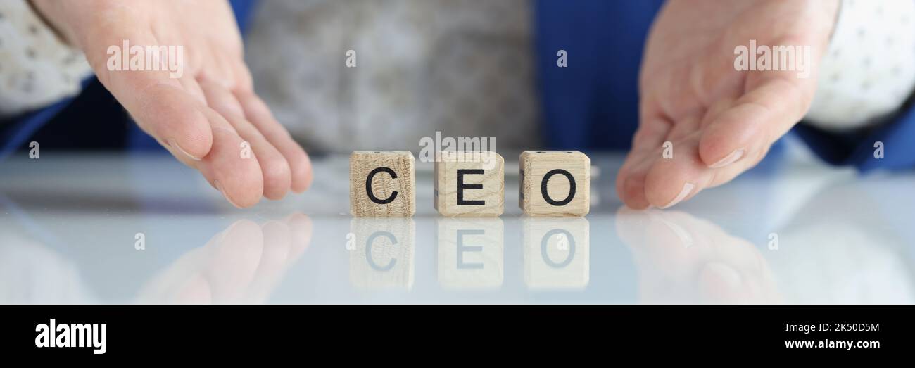 Word CEO on wooden blocks and businessman Stock Photo - Alamy