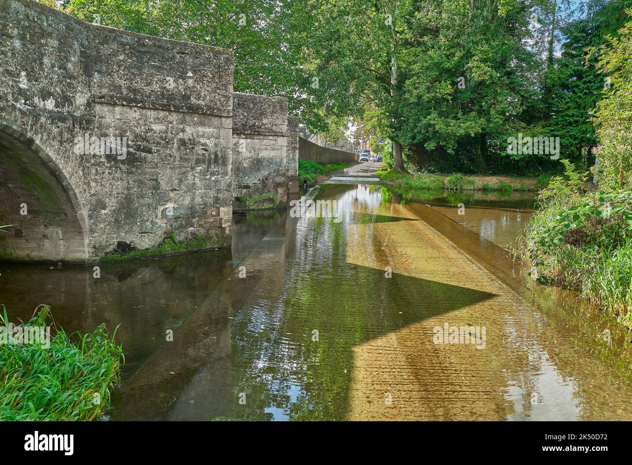 The thirteenth century bridge over the river Ise with the later ford ...