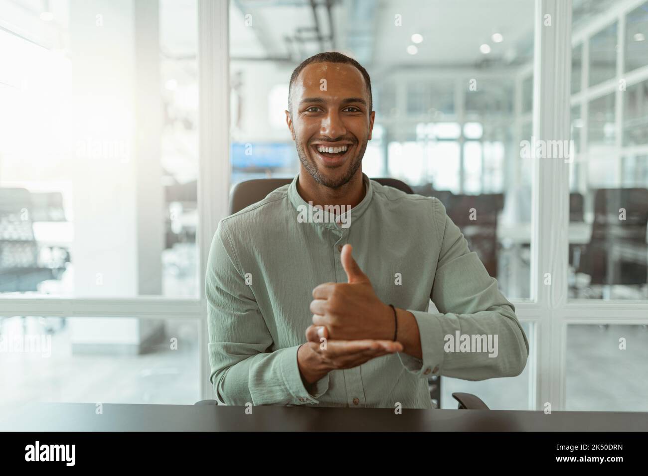 African businessman using sign language while talking online with ...