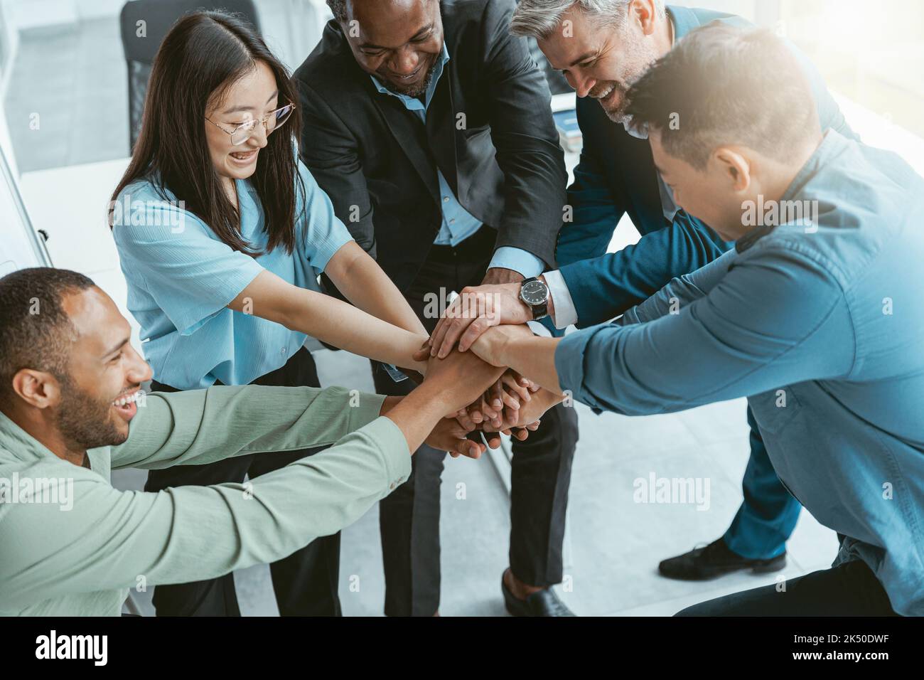 Top view of group multi ethnic coworkers stacked hands together as ...