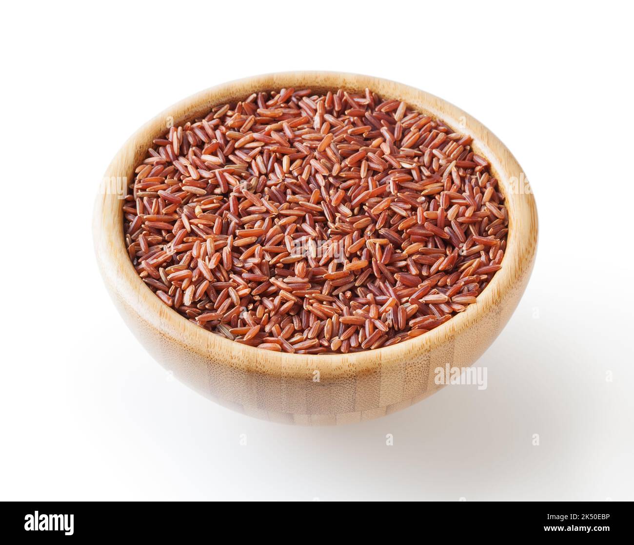 Uncooked red rice in wooden bowl isolated on white background with ...