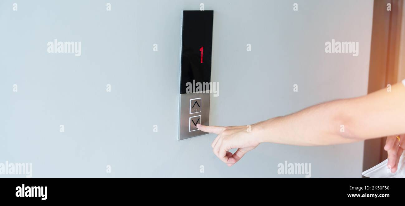 Hand finger press the Elevator button, woman waiting for Elevator in ...
