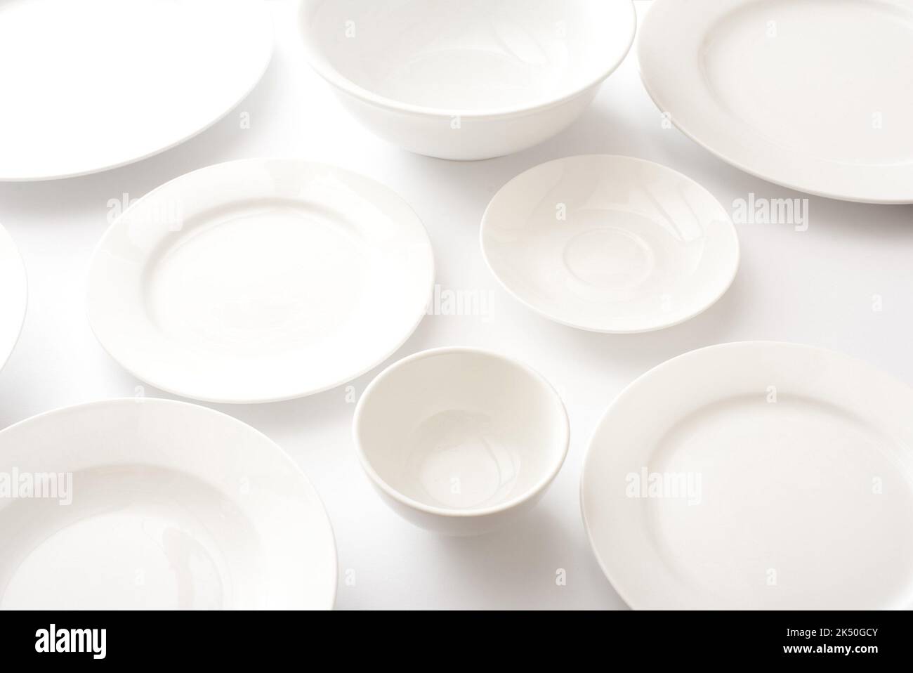 Plain clean empty generic white tableware over a white background with ...