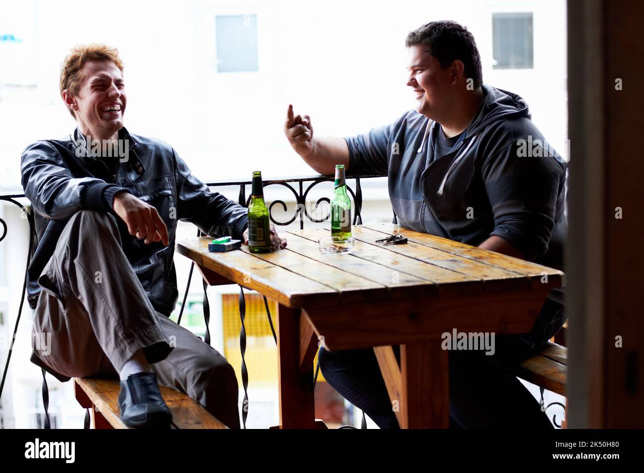 Bonding over a beer. Two young men sitting at a restaurant drinking ...