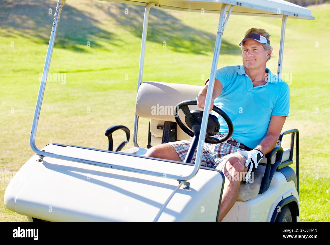 Seated man driving golf cart hi-res stock photography and images - Alamy