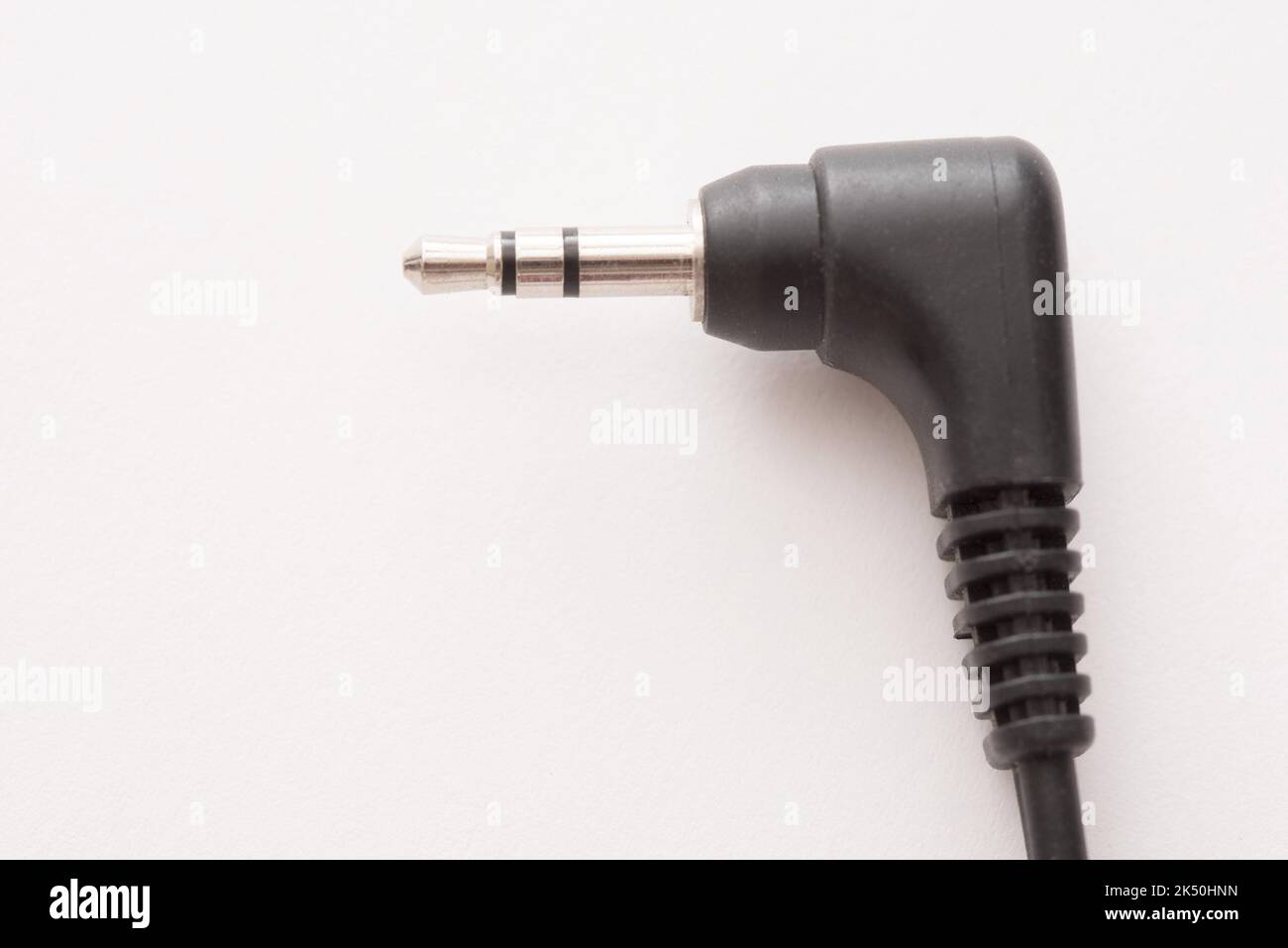 Simple black plastic stereo jack audio plug close-up on white ...