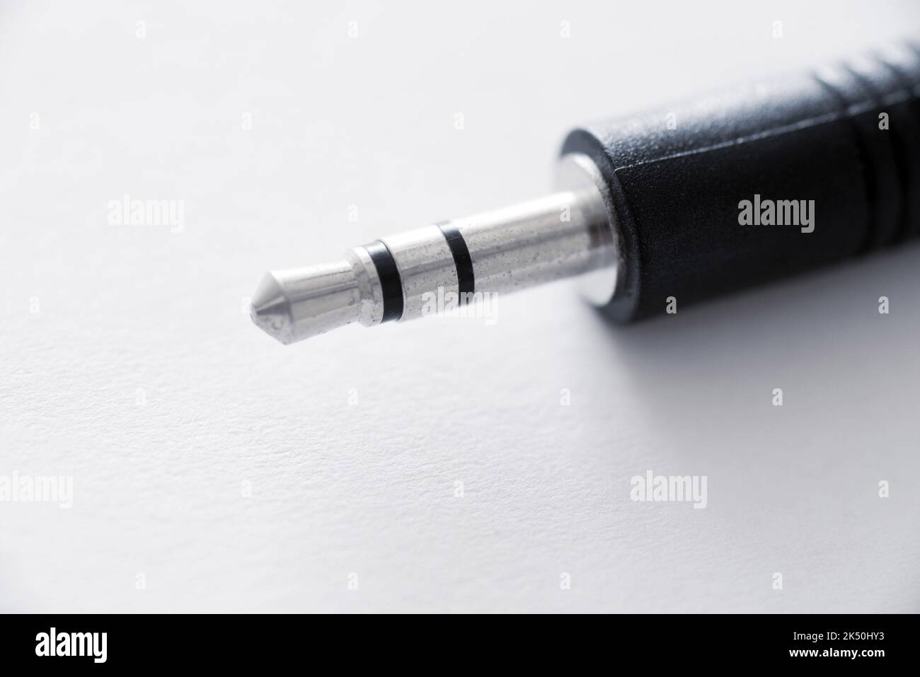 Close-up view of mini jack plug against white background Stock Photo ...