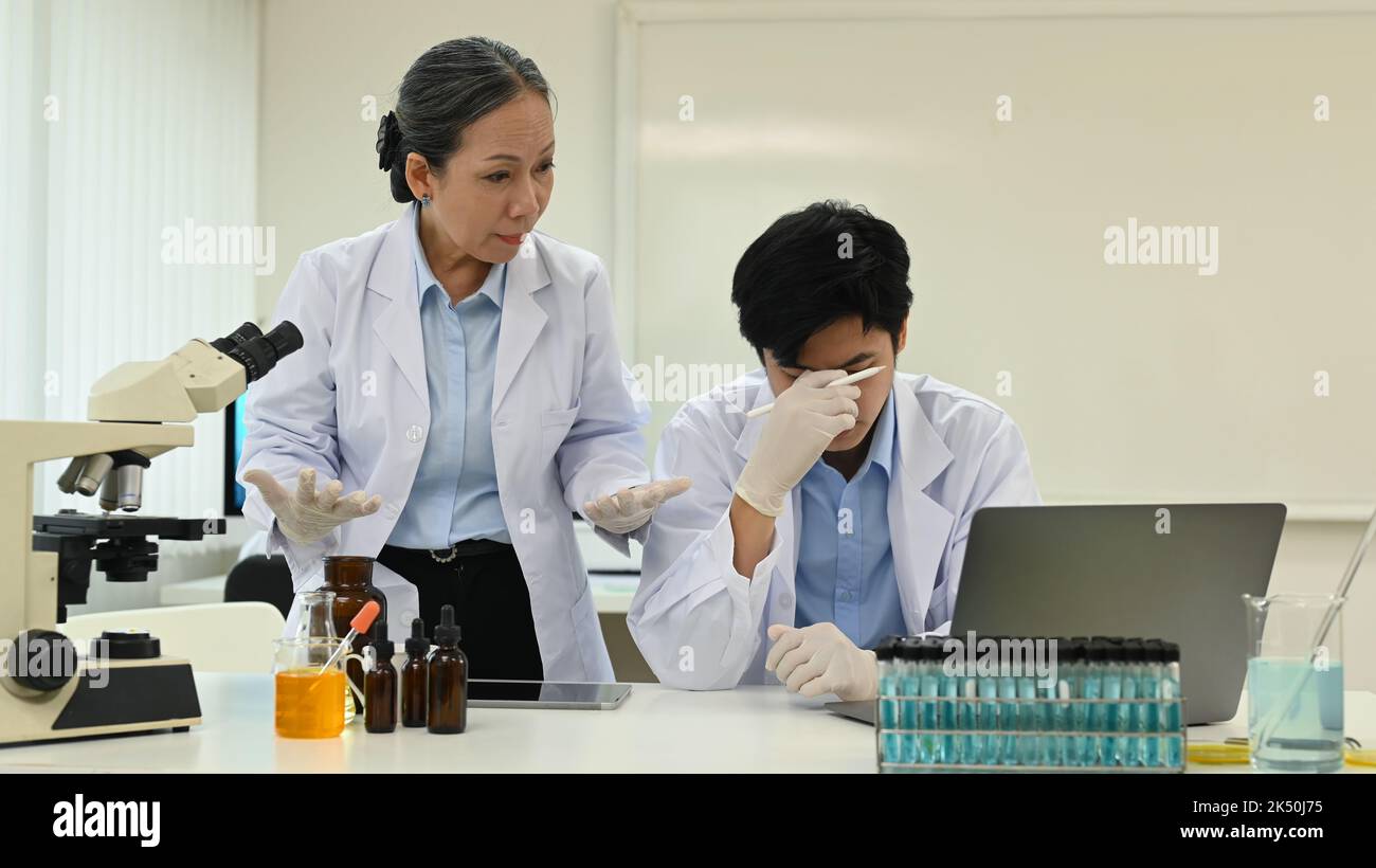 Professional scientists team conducting experiment in modern laboratory. Medicine and science ...