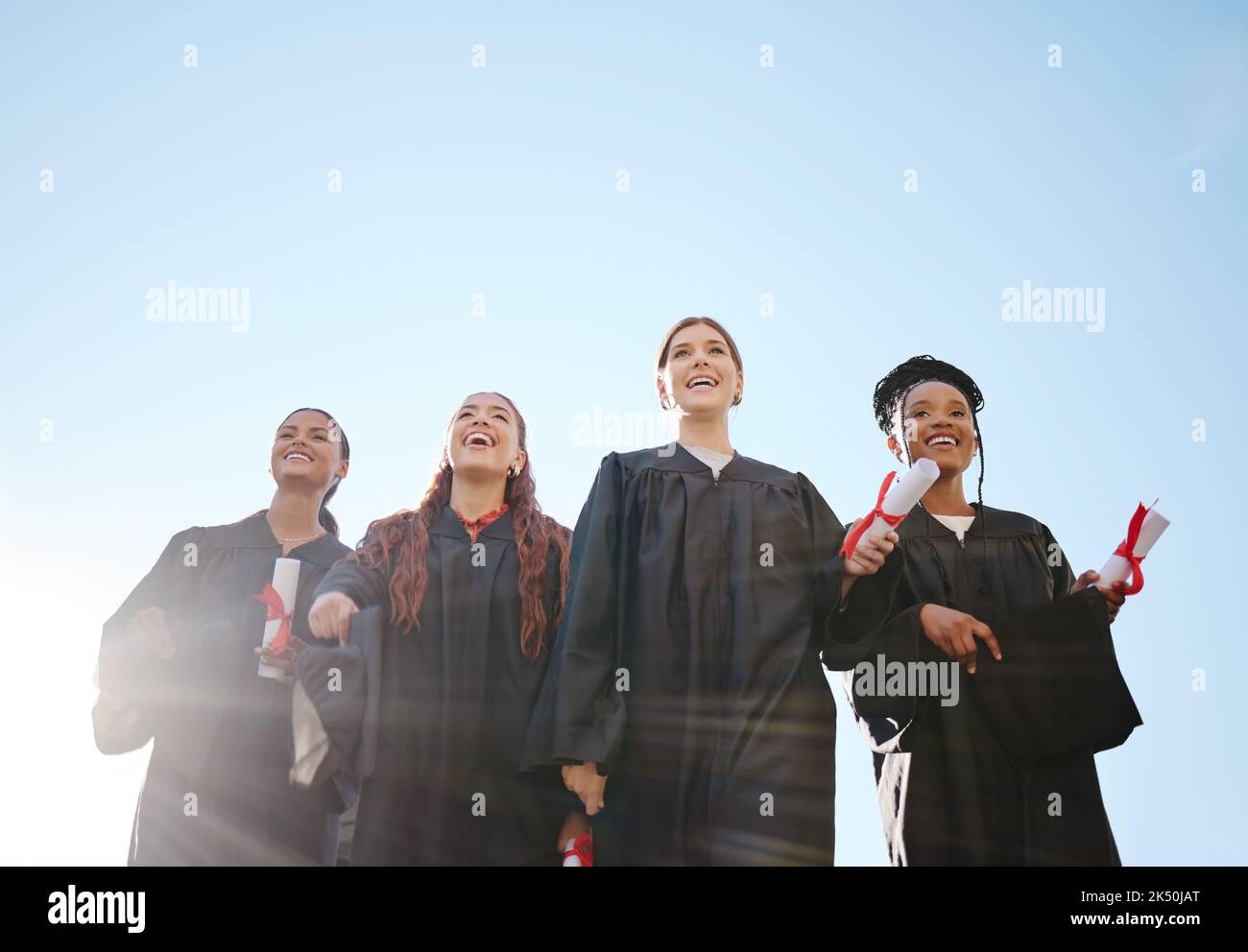 Degree, graduation and graduate class student friends happy at a ...