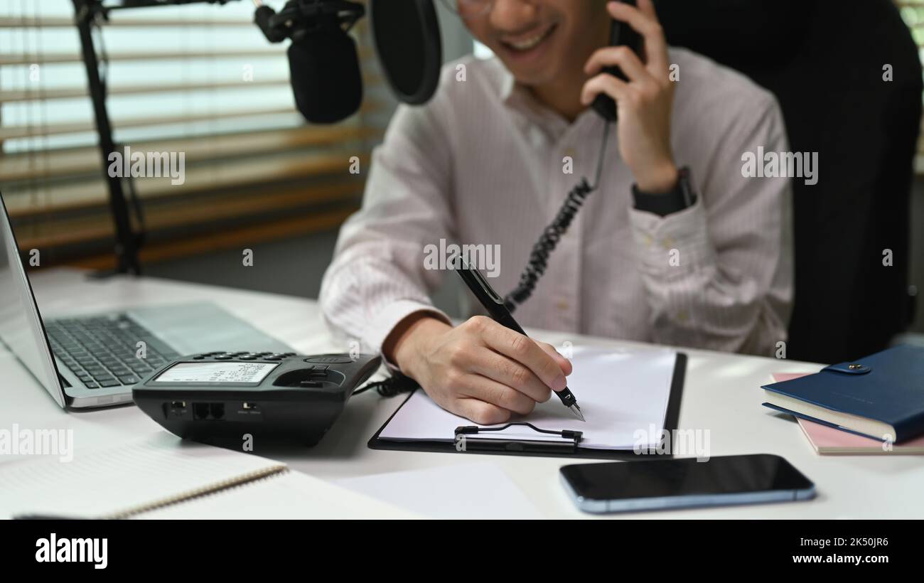 Image of radio host using microphone and laptop to recording podcast in ...