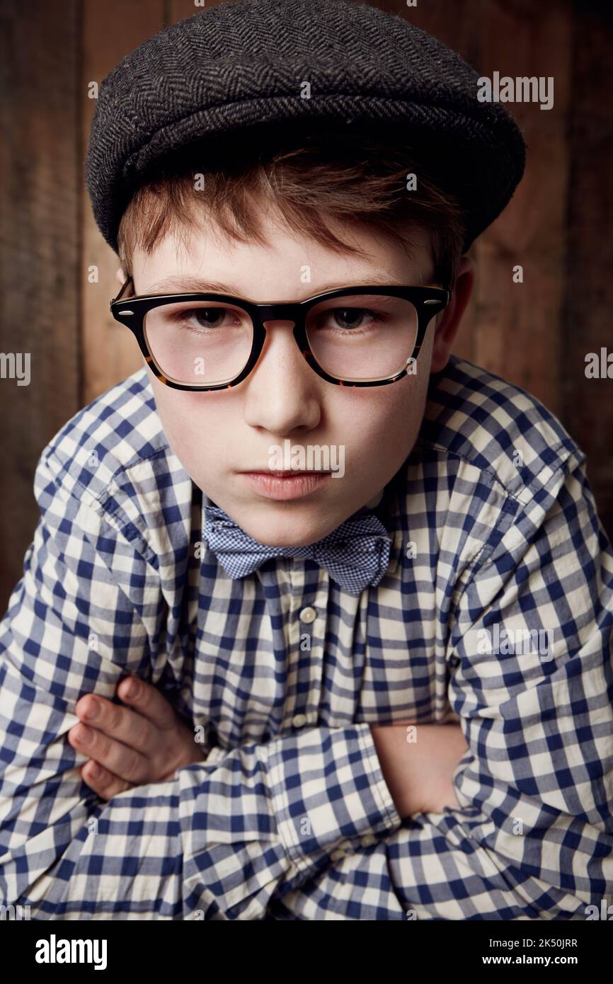 Lets get serious...Young boy in retro clothing wearing spectacles with ...