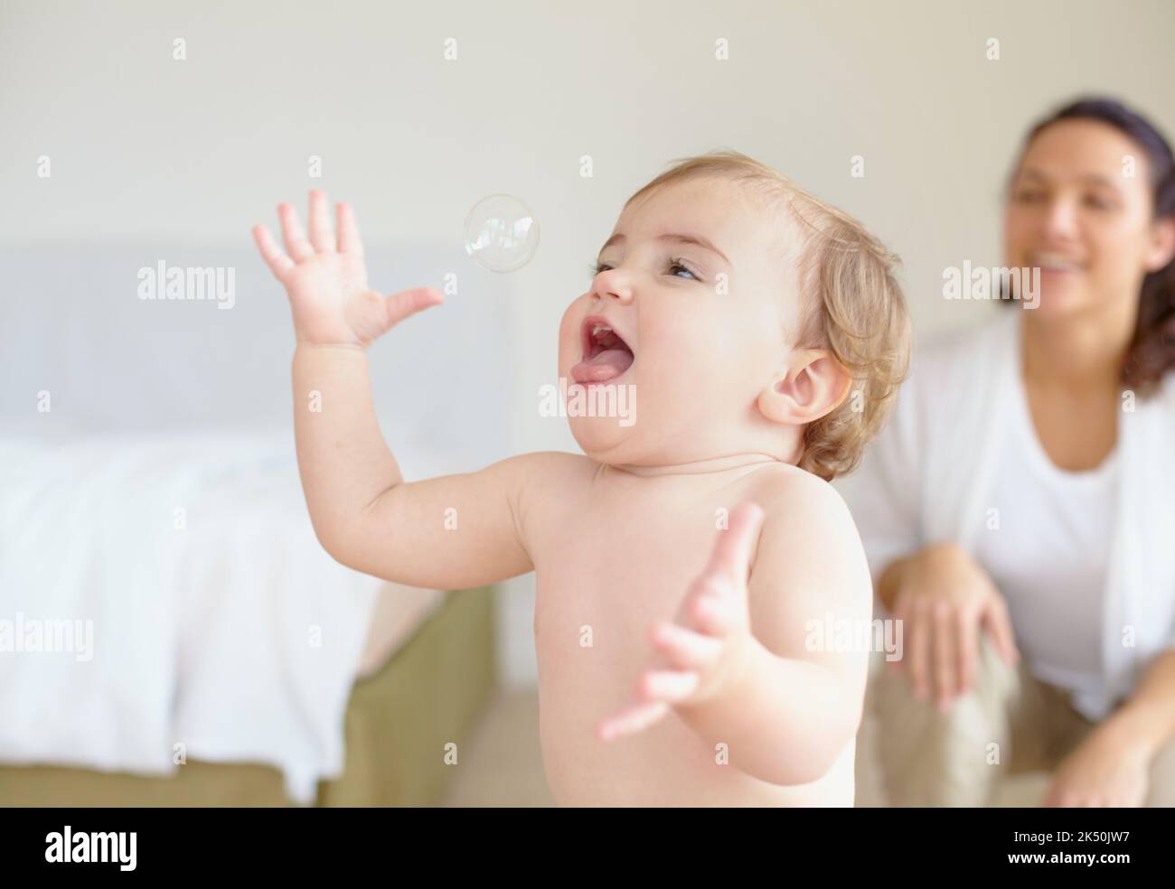 These bubbles are mind-blowing. An adorable baby girl reaching for a ...