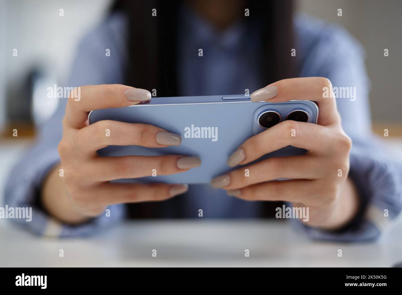 Gamer playing mobile games on smartphone. Young girl plays video game ...