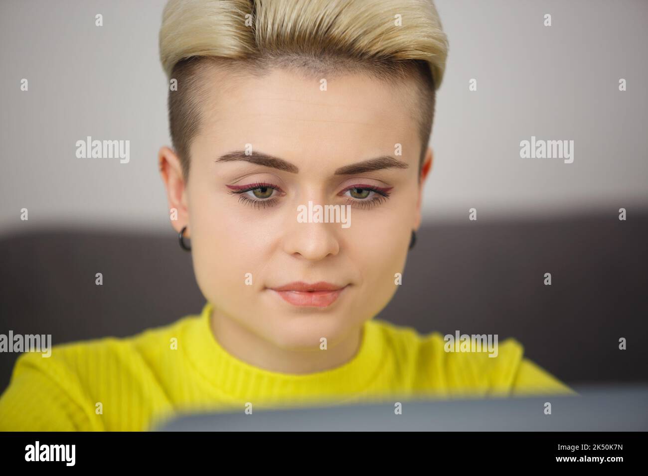 Short haired tom boy person working on computer. Focused white female ... Short haired tom boy person working on computer. Focused white female ...