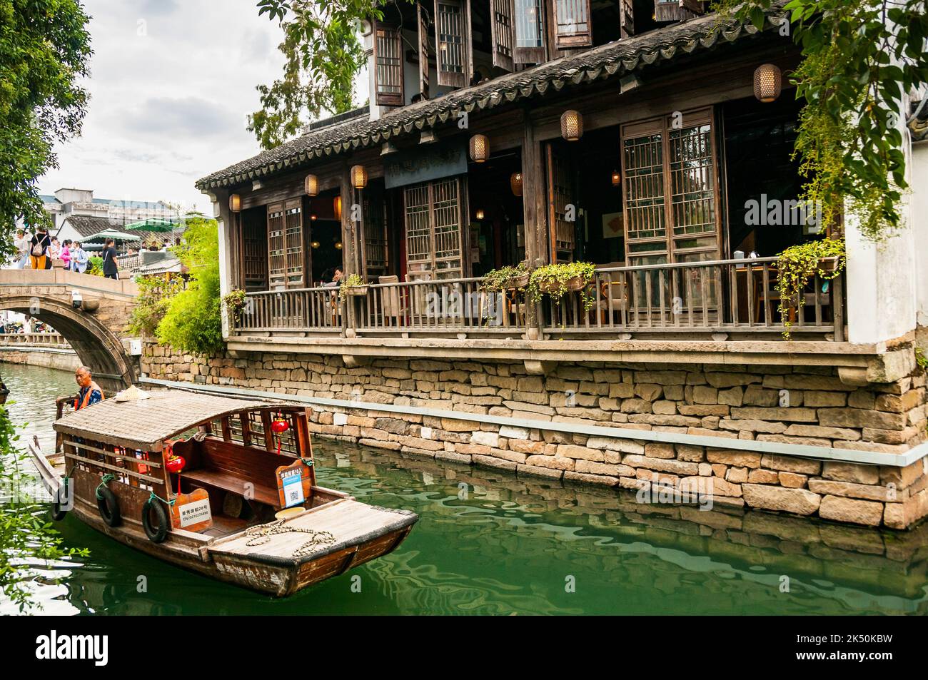 A tourist boat passing a teahouse on Pingjiang River alongside ...