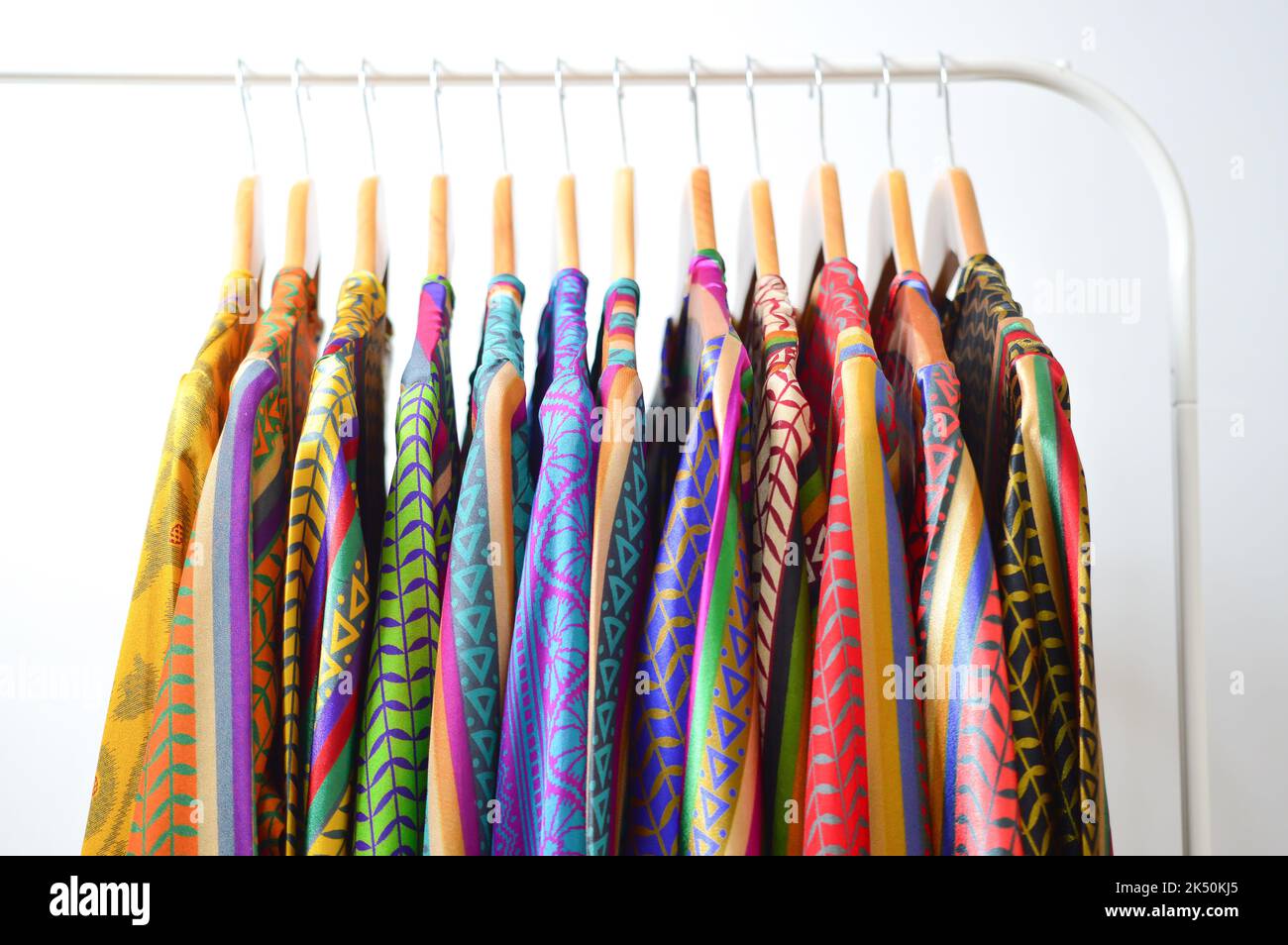Fashionable clothes in a boutique store. Colourful clothes isolated ...