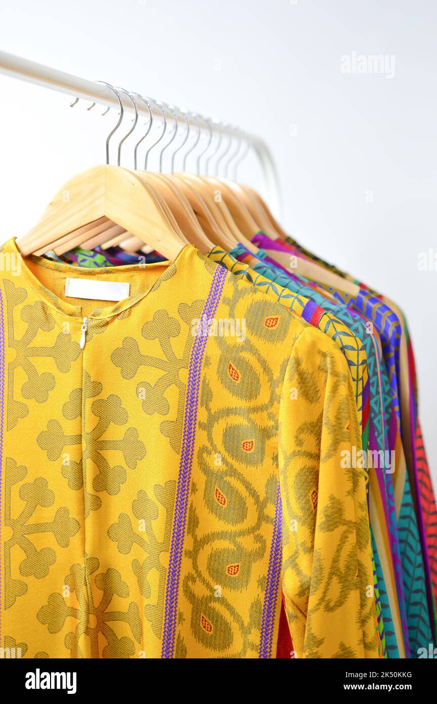 Fashionable clothes in a boutique store. Colourful clothes isolated ...