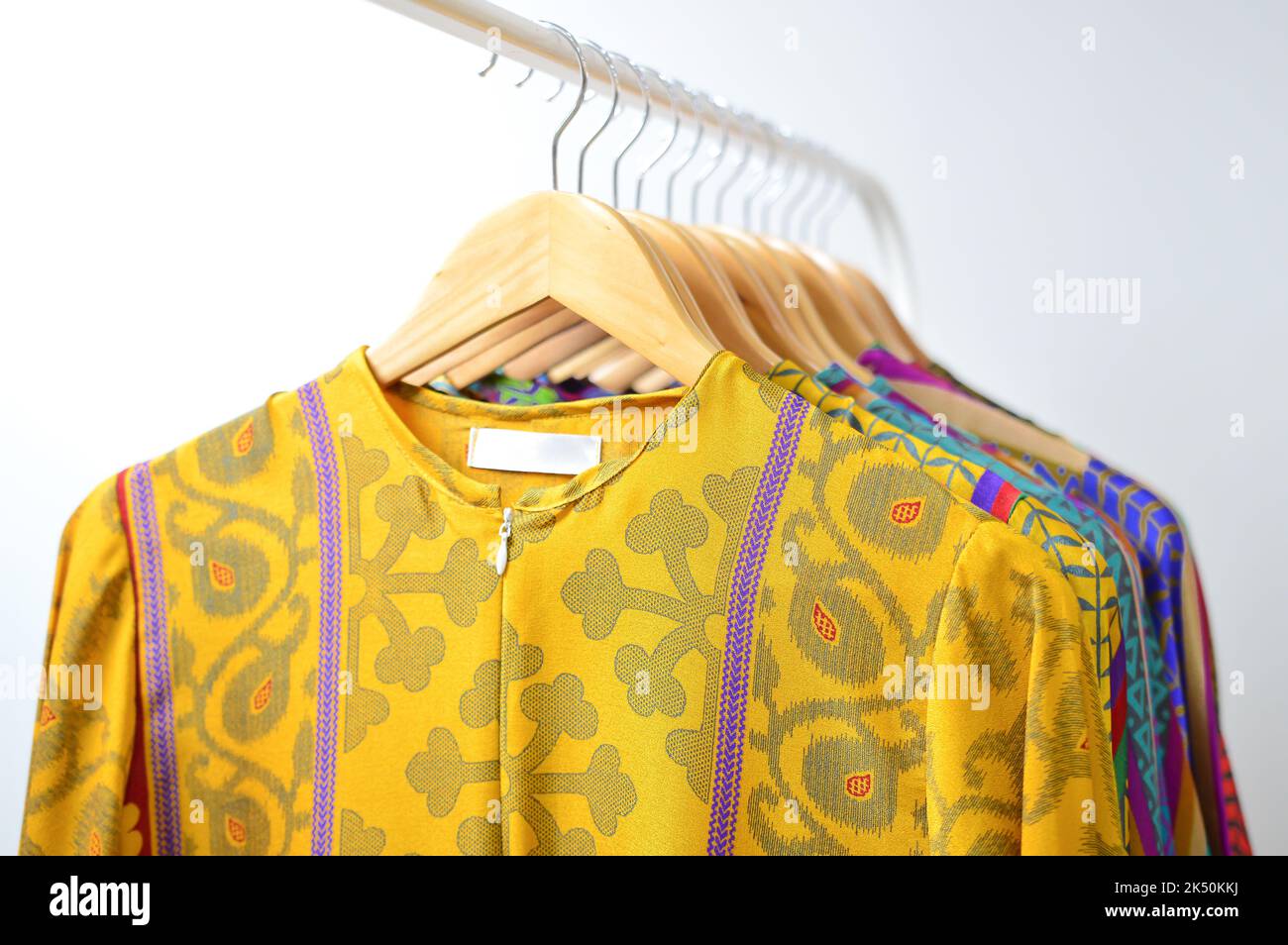 Fashionable clothes in a boutique store. Colourful clothes isolated ...