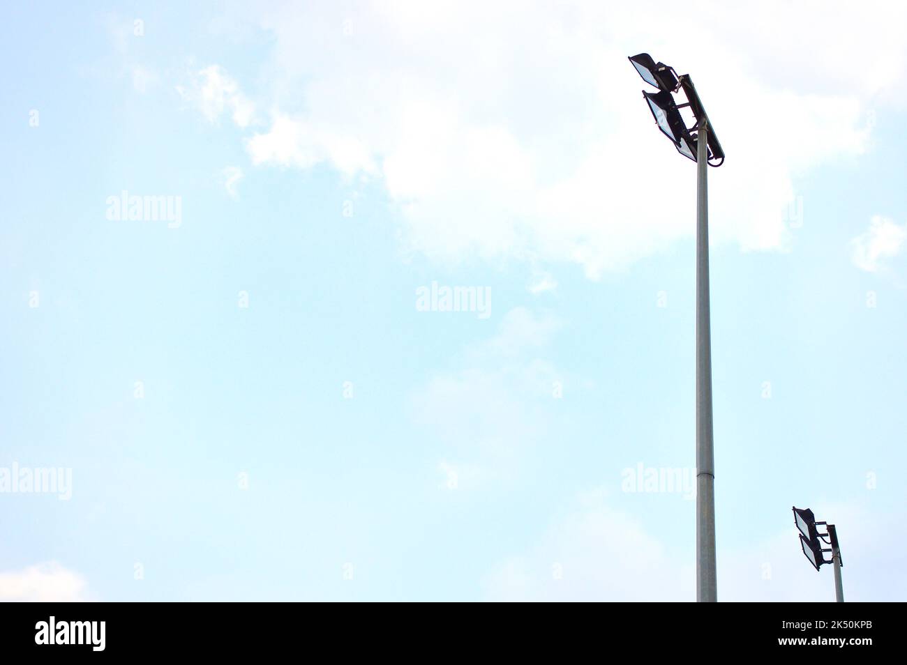 Tall sport stadium light stanchion or light tower from low angle in ...