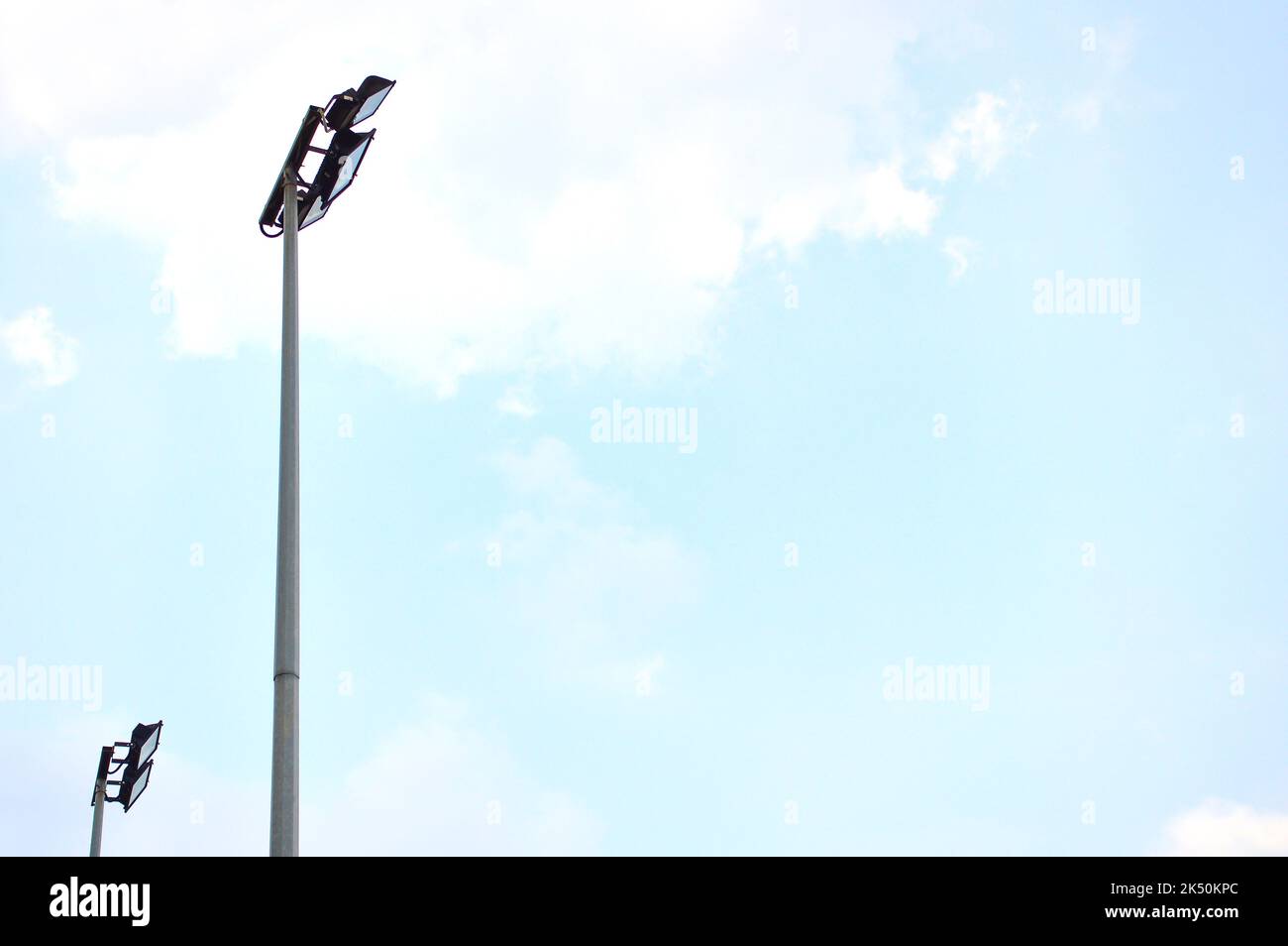 Tall sport stadium light stanchion or light tower from low angle in ...