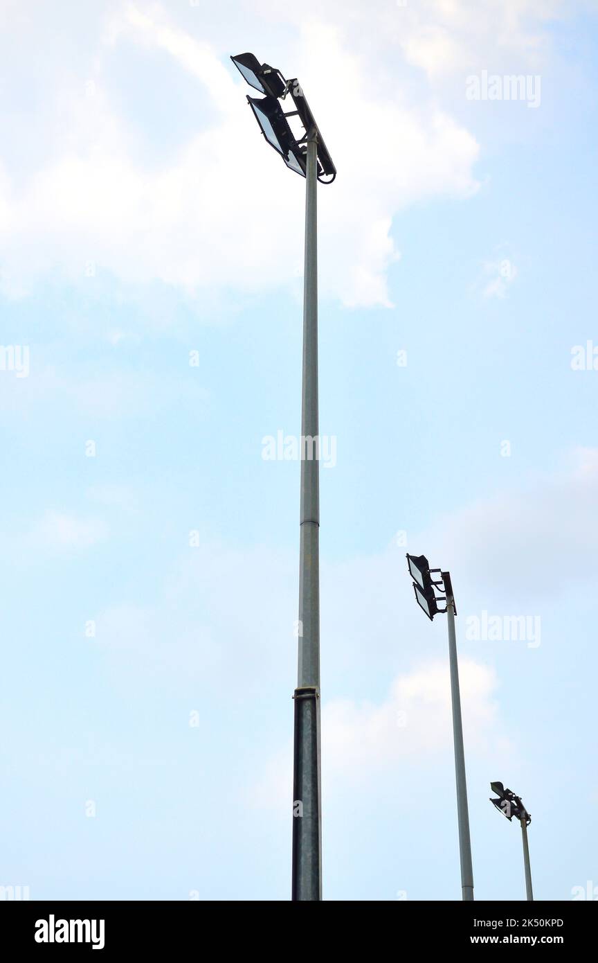 Tall sport stadium light stanchion or light tower from low angle in ...