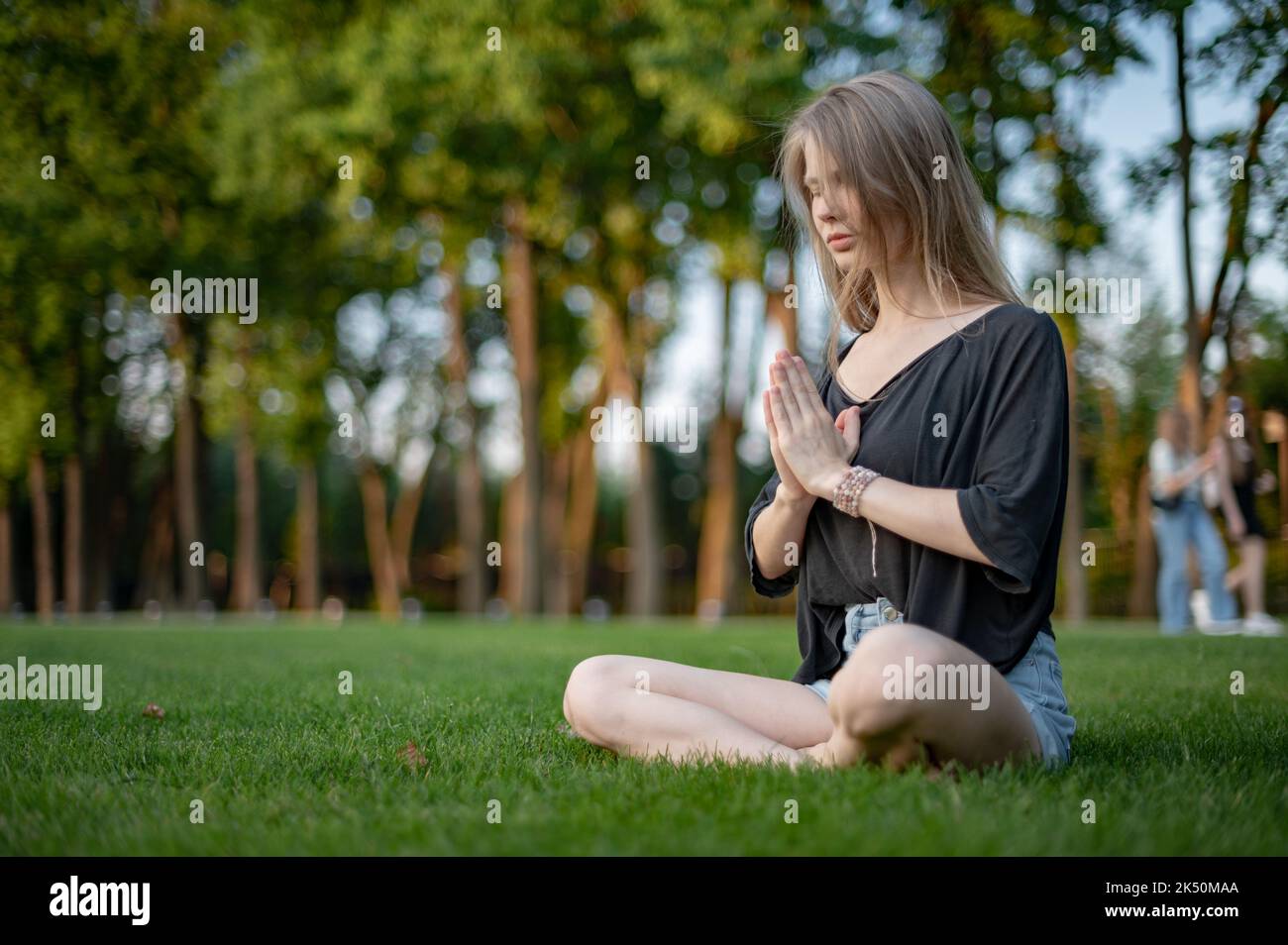 Girl practice yoga meditation outdoor in park Stock Photo - Alamy