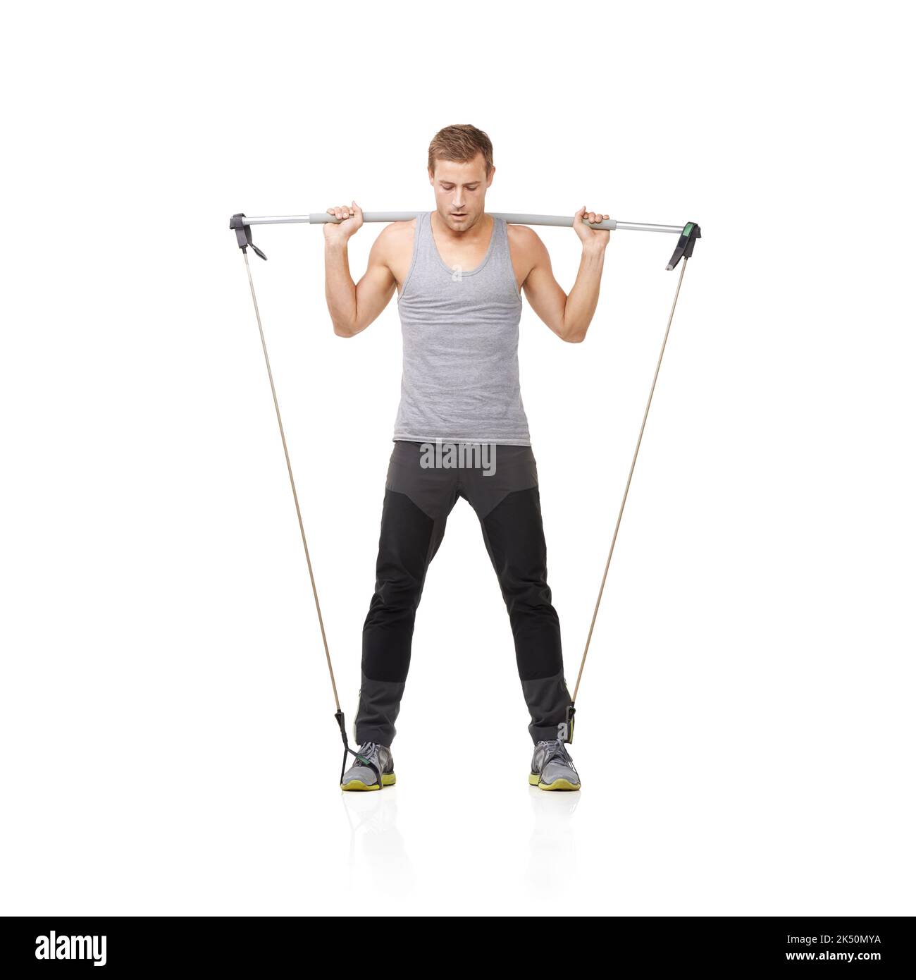 Witness the fitness. A young man using a resistance band to tone his ...