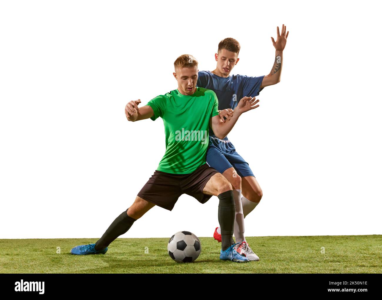 Two soccer players in action, motion on green grass flooring isolated ...