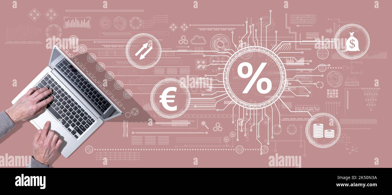 Top view of hands using laptop with symbol of interest rates concept ...