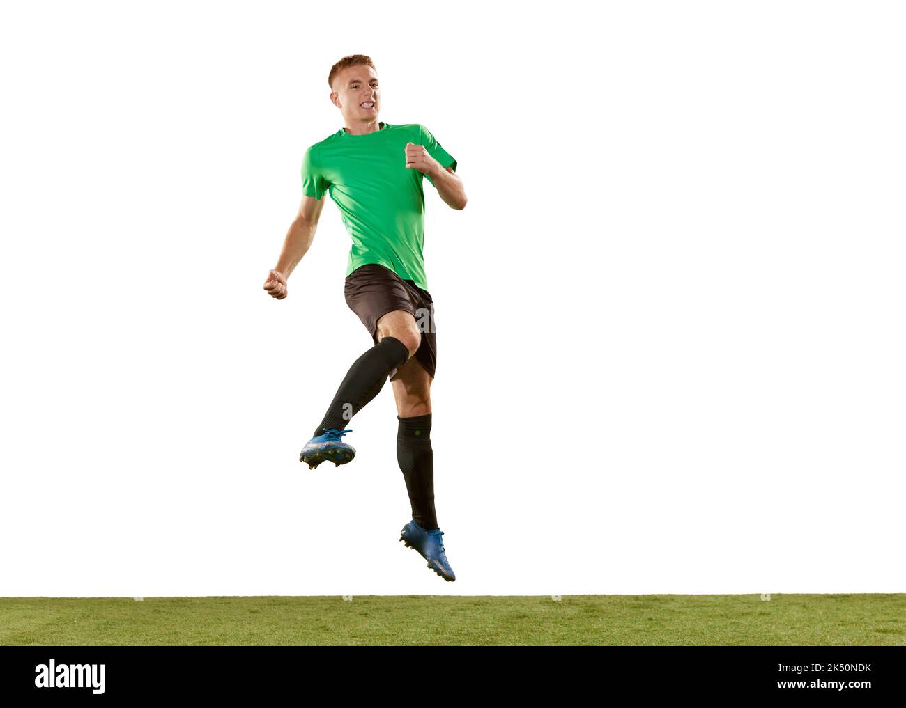 One young man, professional soccer football player jumping isolated on ...